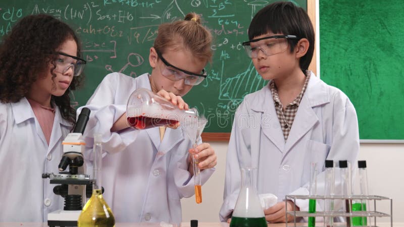 Caucasian Student Doing Experiment and Pouring Solution at Laboratory ...