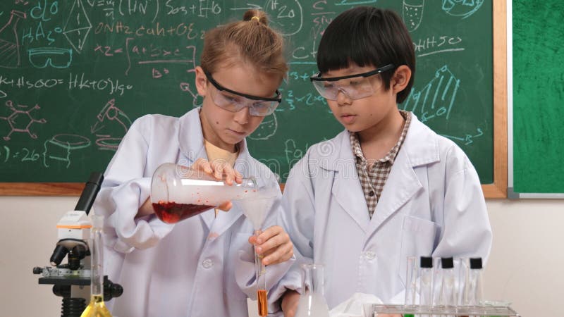 Caucasian Student Doing Experiment and Pouring Solution at Laboratory ...