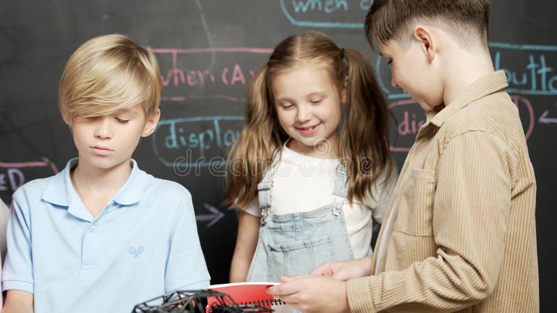 Caucasian Student Group Checking Robotic Model while Taking a Note ...