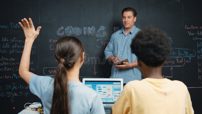 Caucasian Teacher Answering Student Question about Coding Program ...