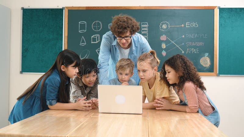 Caucasian Teacher and Diverse Student Looking at Laptop at Classroom. Pedagogy. Stock Photo ...