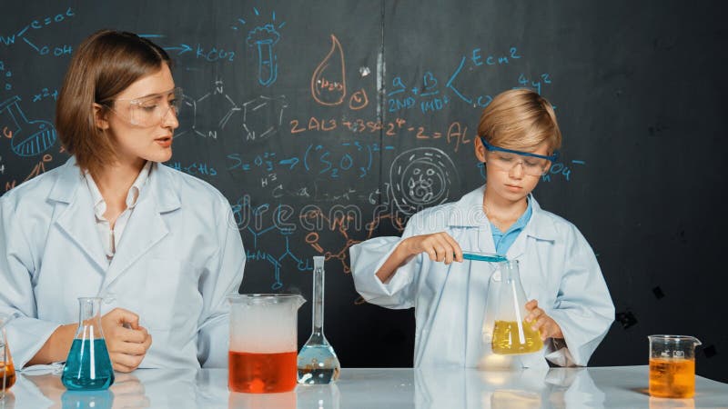 Caucasian Teacher Helps Student Mixed Liquid in Science Laboratory ...