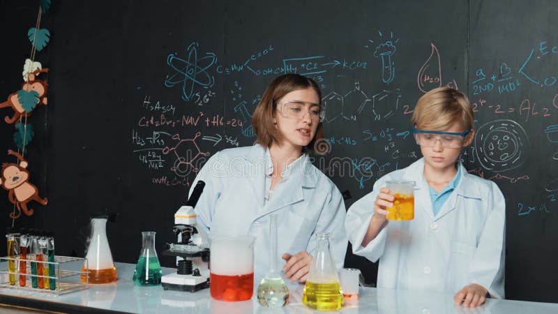 Caucasian Teacher Helps Student Mixed Liquid in Science Laboratory ...