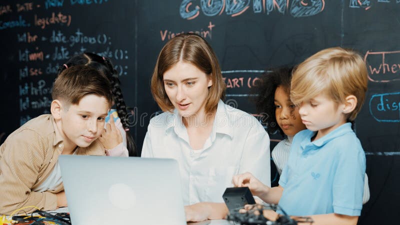 Caucasian Teacher Using Laptop and Explain about Engineering System ...
