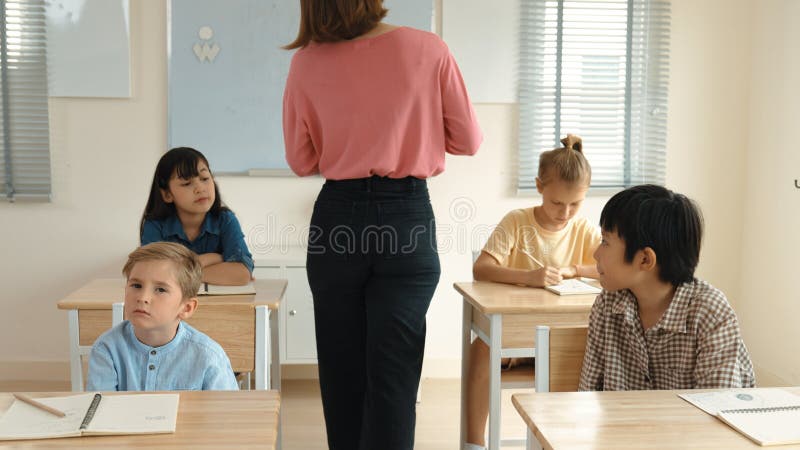 Caucasian Teacher Walking Around Classroom while Explain Classwork ...
