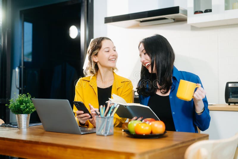 Caucasian Teamwork and Creativity with Sitting Working at Kitchen Table ...