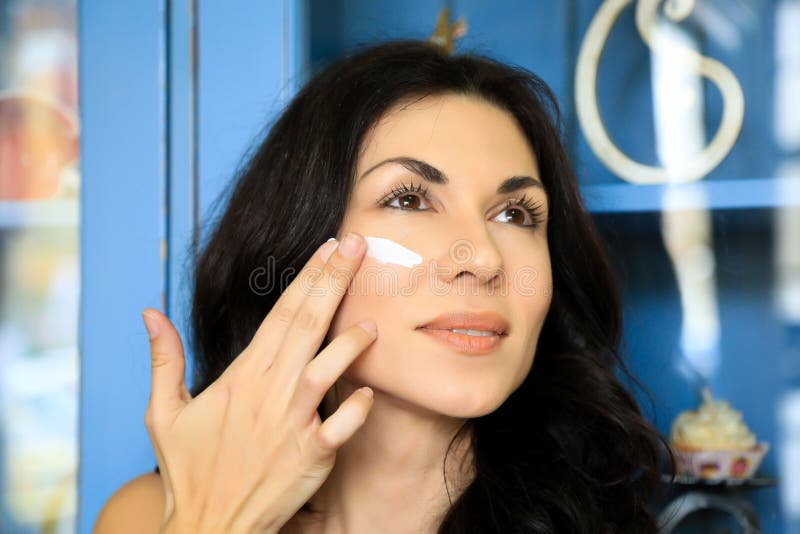 Caucasian Woman Applying Moisturizer On Her Face Skin Care Concept
