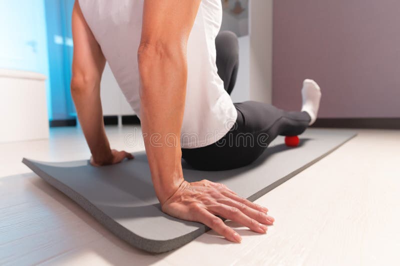 Caucasian Woman Doing Myofascial Foot Massage With Massage Red Ball