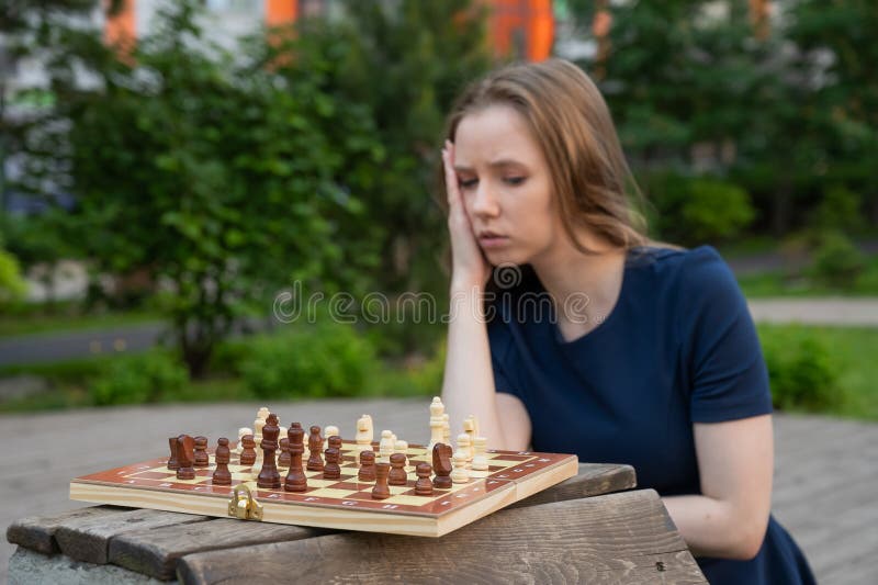 Caucasian Woman Playing Chess Outdoors. Stock Image - Image of young ...