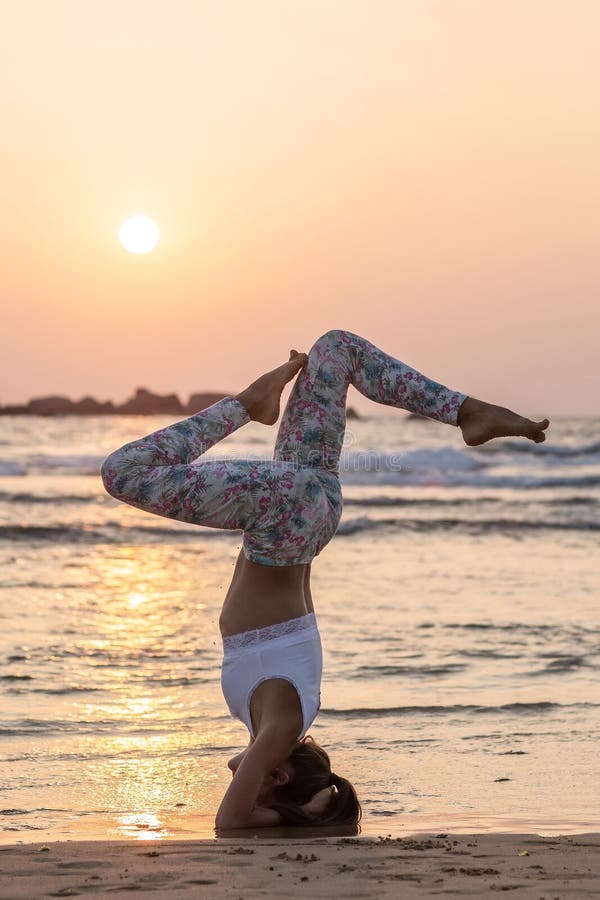 Caucasian Woman Practicing Yoga At Seashore Of Tropic Ocean Stock Image