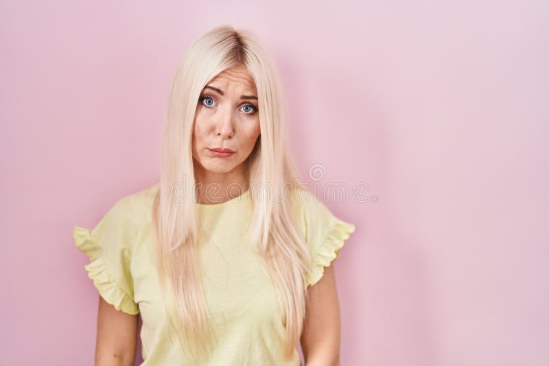 Caucasian Woman Standing Over Pink Background Depressed And Worry For