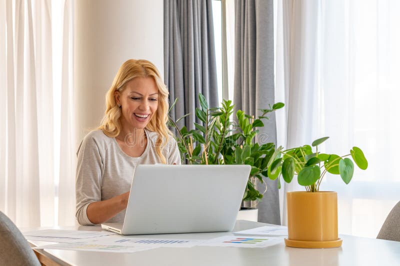 Caucasian Woman Working Remotely on a Laptop and Smiling Stock Image ...