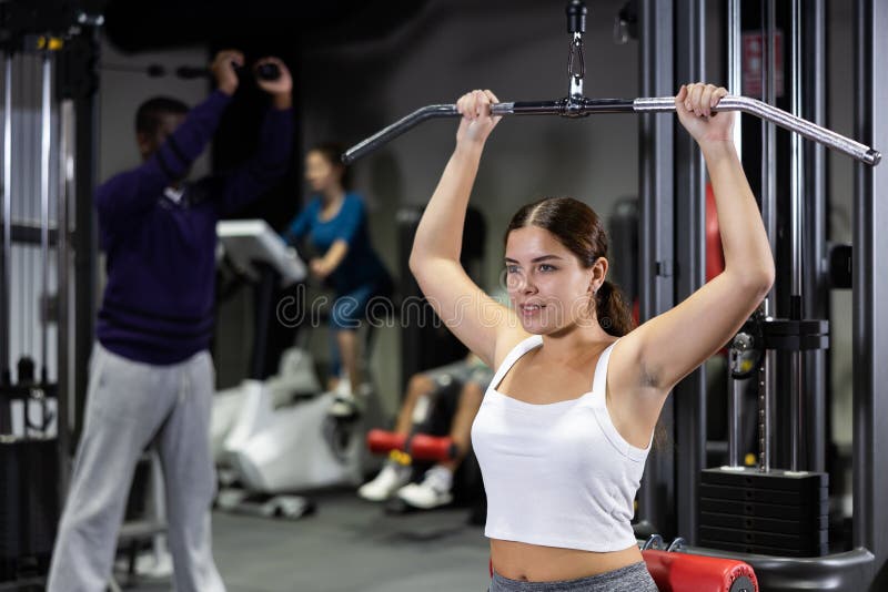 Caucasian Woman Training on Lat Pull Down Machine in Gym Stock Photo ...