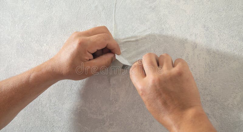 Caucasian Worker Applying Wallpaper To Wall at Home Stock Photo - Image ...