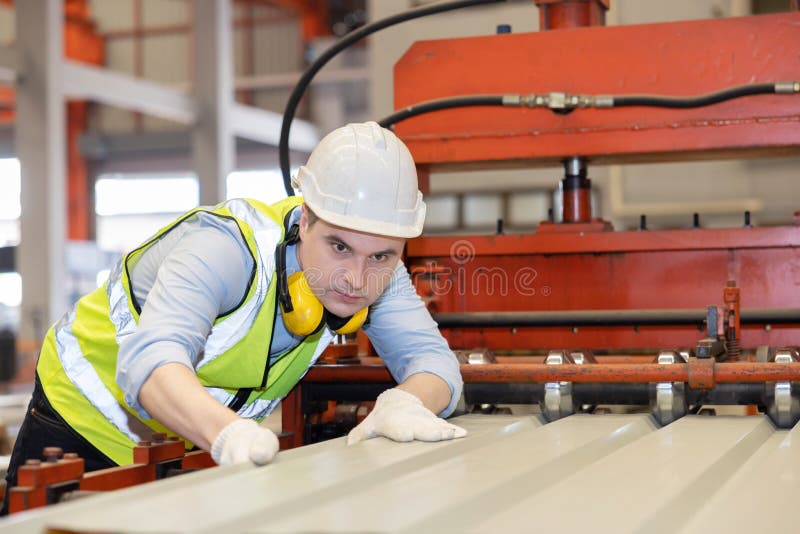 Caucasian Iron Welding Workers with Tablet in Front of the Red Steel ...