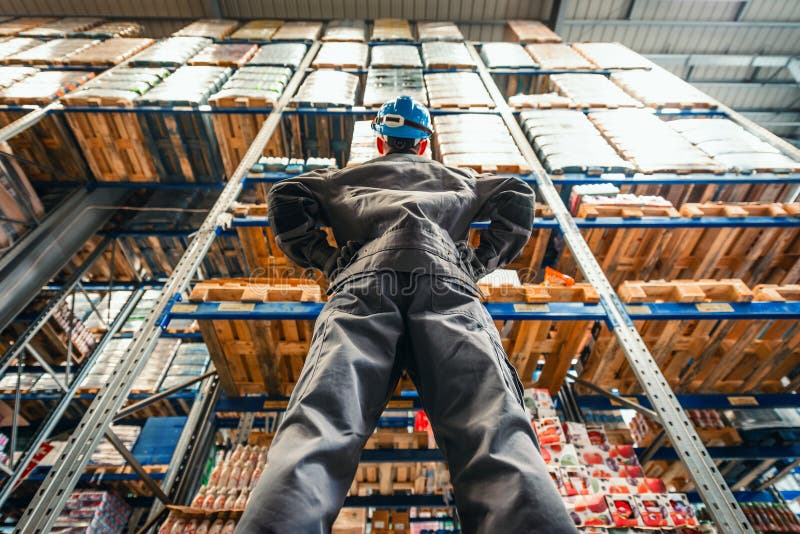Caucasian Worker in Uniform Looking for Packaging. a Close-up Photo ...