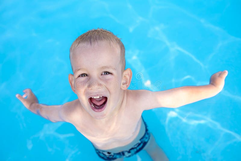 Caucasian Young Boy Swimming in the Pool and Happily Smiling Stock ...