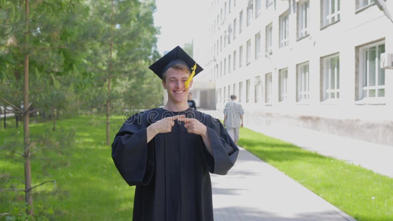 Caucasian Young Man in Graduation Gown Communicating Using Sign ...