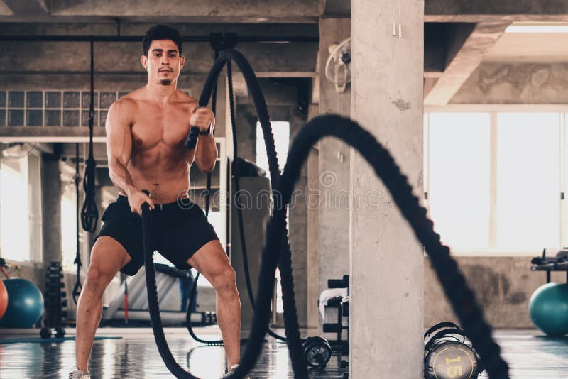 Caucasian Young Man Having Workout in Gym with Rope Stock Photo - Image ...