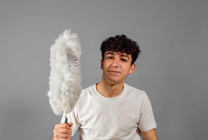 Caucasian Young Man Posing Funny with a Cleaning Duster on Blue Studio ...