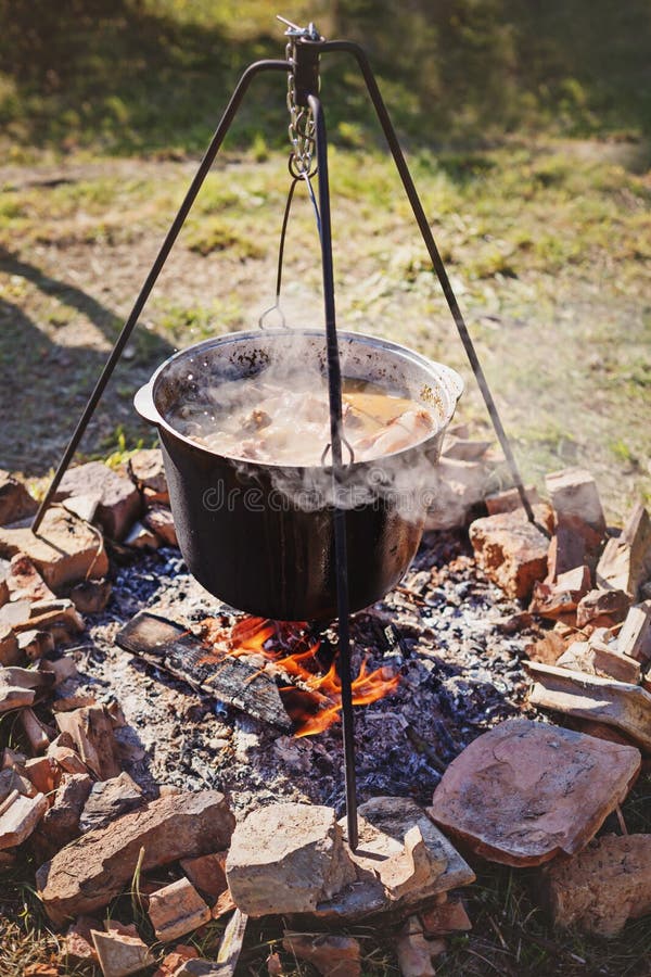 Cooking Outdoors in Cast Iron Cauldron on a Campfire Stock Image ...