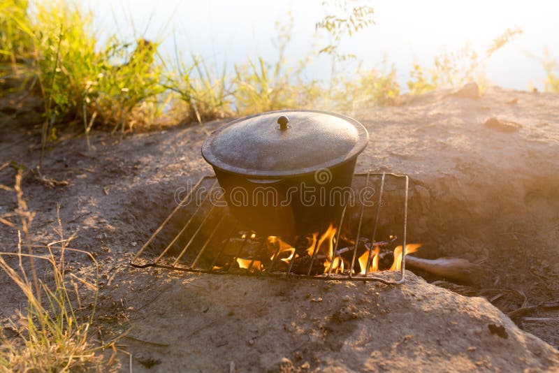 Cauldron on fire at sunset stock image. Image of fire - 111117263