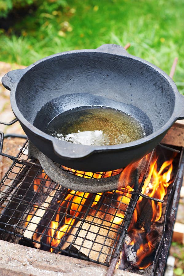 Cauldron of Oil for Pilaf on Lattice of Barbecue. Stock Photo - Image ...