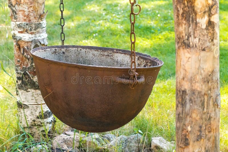 Cauldron, Pot for Cooking Hanging on Chains Over the Fire. Stock Photo ...