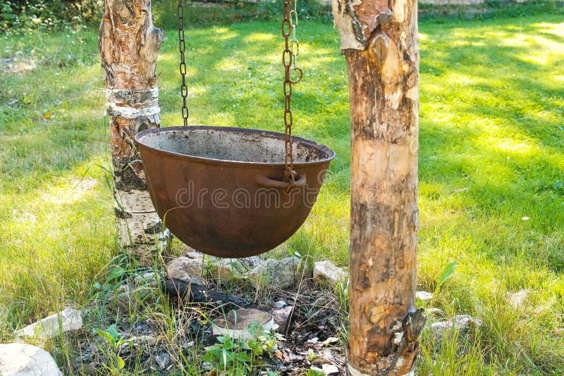 Cauldron, Pot for Cooking Hanging on Chains Over the Fire. Stock Image ...