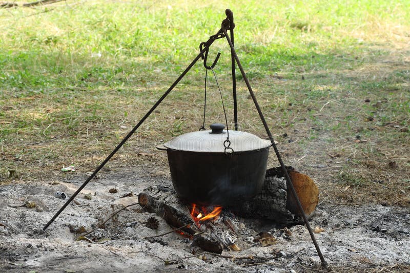 The Cauldron is Suspended on a Tripod Over the Fire. Cooking Lunch at a ...