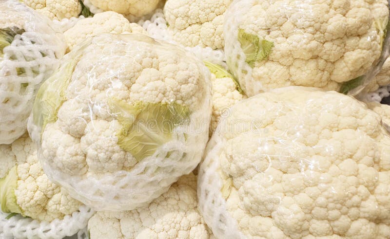 Cauliflower Pile in Plastic Wrap Stock Photo - Image of packaging ...