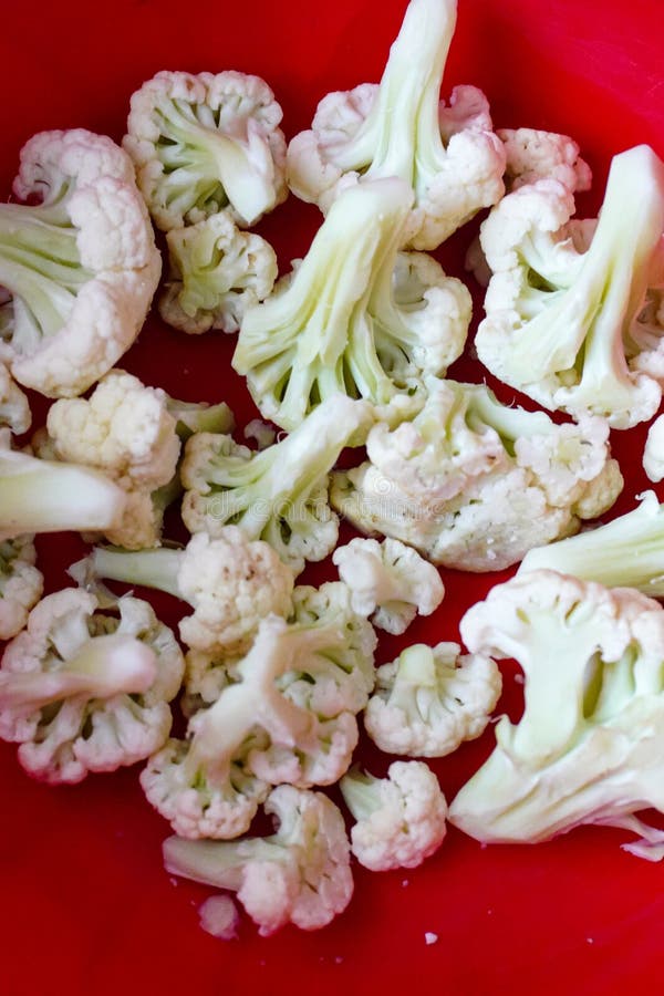 Cauliflower, Stack of Cauliflower in the Background. on a Red ...