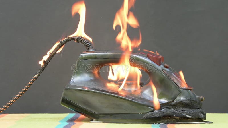 A Fire from an Electric Iron on an Ironing Board in an Apartment, a ...