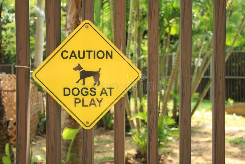 Caution – Dogs at Play Sign Outside a Pet Park Stock Photo - Image of ...