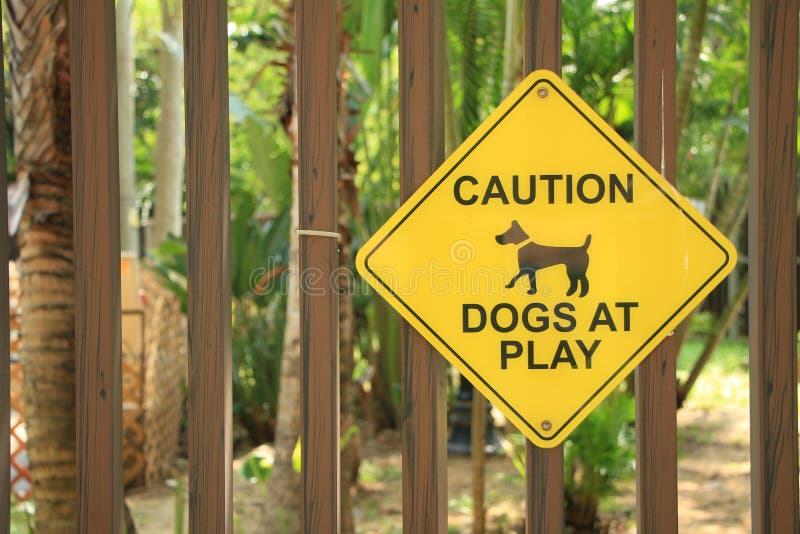 Caution â€“ Dogs at Play Sign Outside a Pet Park Stock Photo - Image of ...