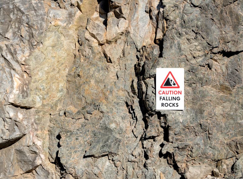 CAUTION FALLING ROCKS sign stock photo. Image of hazard - 202630832