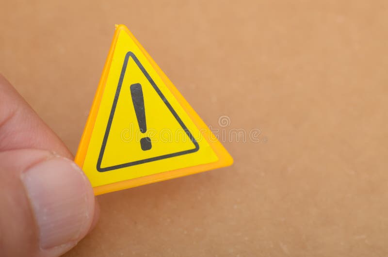 Caution in Hand: Yellow Warning Triangle with Black Exclamation Mark ...