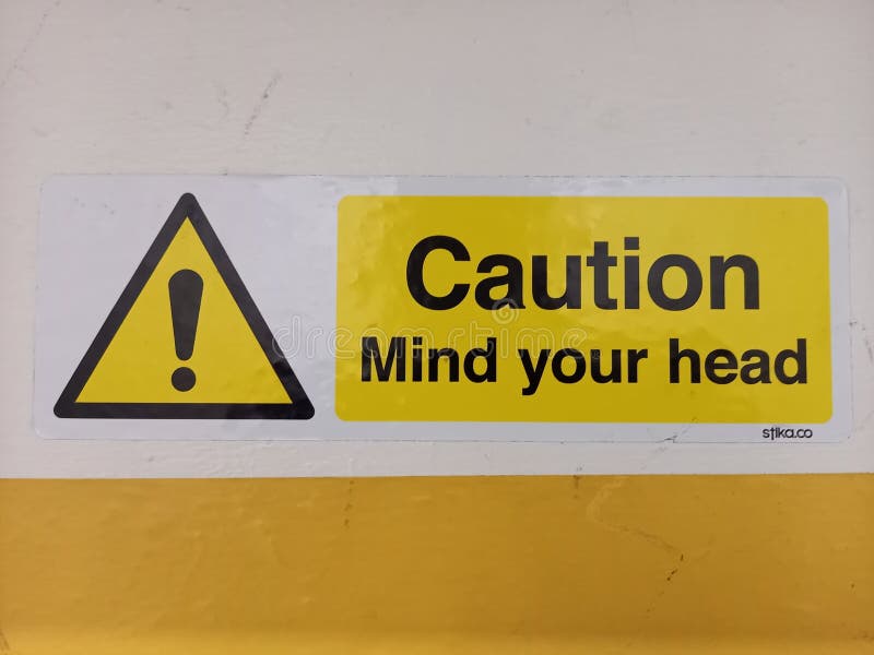 Caution Mind Your Head Warning Sign on White and Yellow Background ...