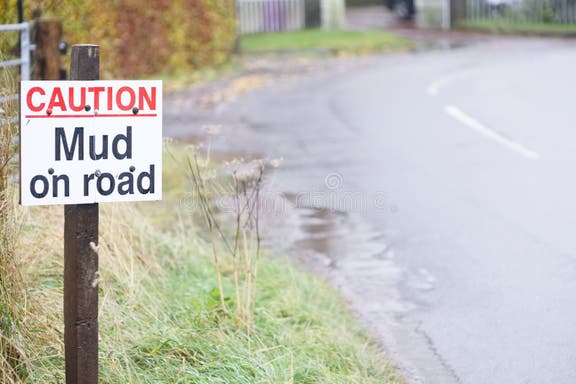 Caution Mud on Road Sign at Bend Stock Photo - Image of slow, lane ...