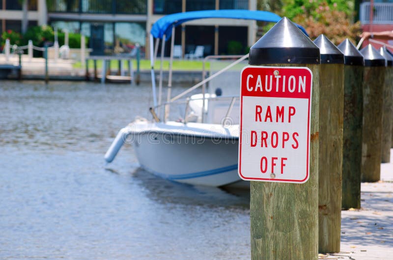 Caution sign at boat ramp stock photo. Image of issues - 25521754