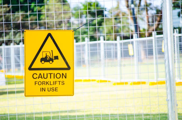 Caution Sign for Forklifts in Use Attached To the Steel Fence. Stock ... Caution Sign for Forklifts in Use Attached To the Steel Fence. Stock ...