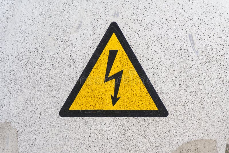 Caution Sign Indicating Electrical Hazard on Concrete Wall in Urban ...