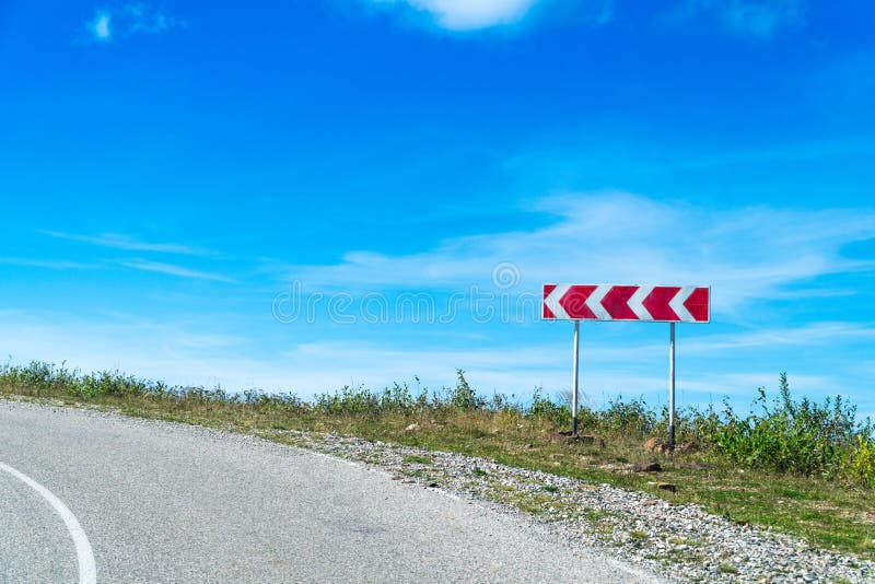 Caution Sign at the Sharp Turn Stock Image - Image of green, path ...