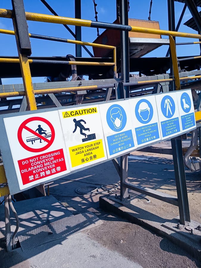 Caution Signs Displayed at Industrial Conveyor System for Worker Safety ...
