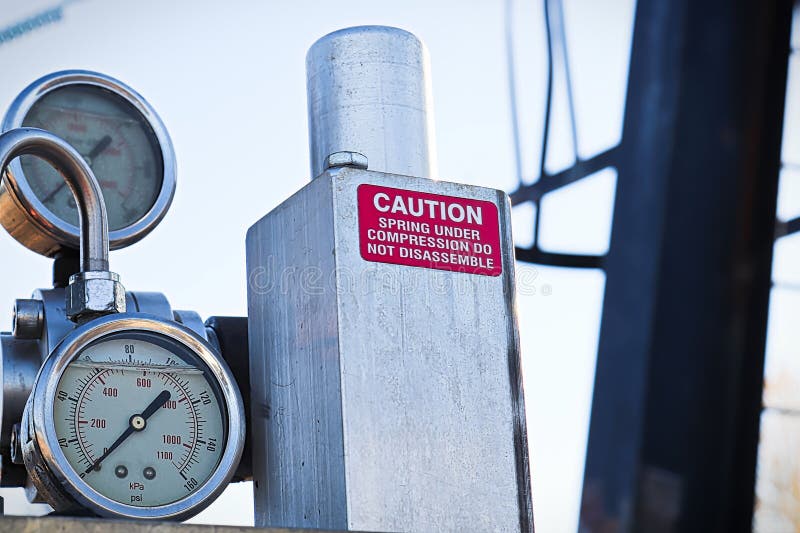 A Caution Spring Under Pressure Do Not Disassemble Sign Stock Image ...