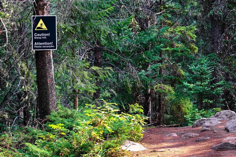 A Caution Steep Hill Sign on a Edge of a Trail Stock Photo - Image of ...