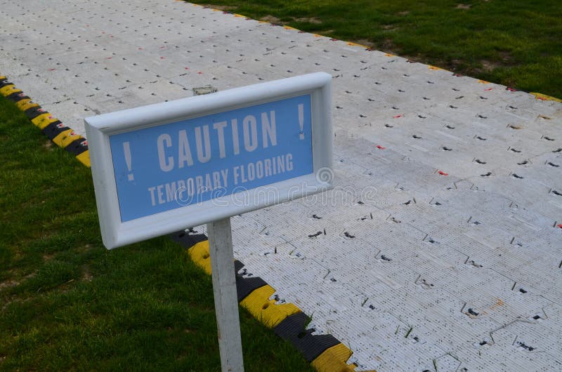 Caution Temporary Flooring Sign. Stock Image - Image of grass, covering ...