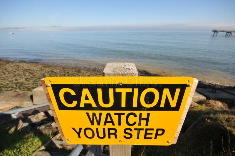 Caution Watch Your Step Sign by the Ocean Stock Photo - Image of steps ...