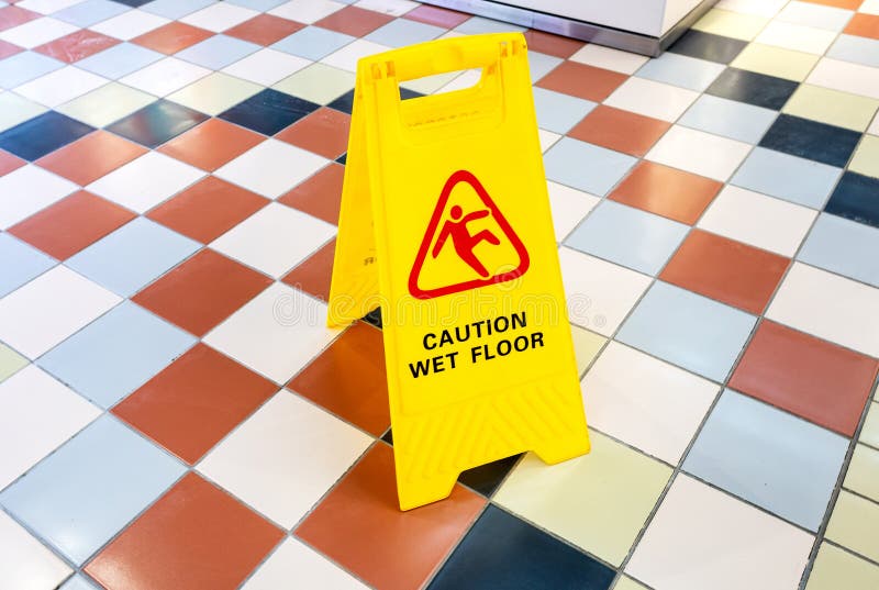 Caution Wet Floor Warning Sign on a Tile Floor in a Superstore Stock ...