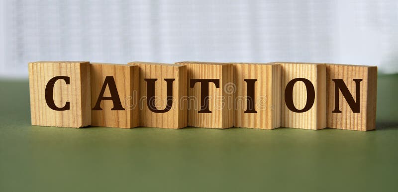 CAUTION - Word on Wooden Blocks on Light Background Stock Photo - Image ...